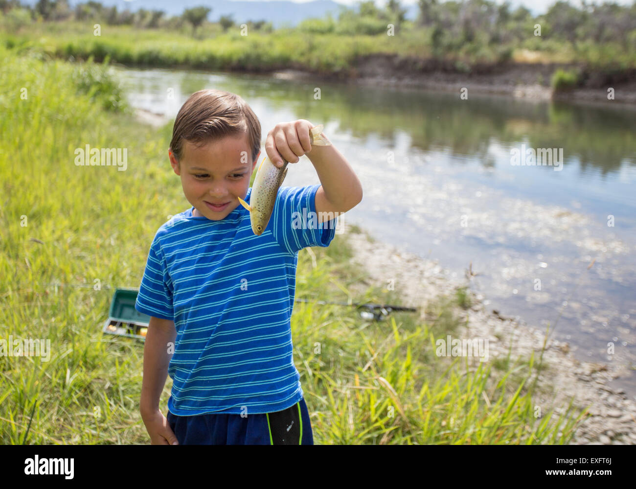 Young boy showing the fish he caught Stock Photo - Alamy