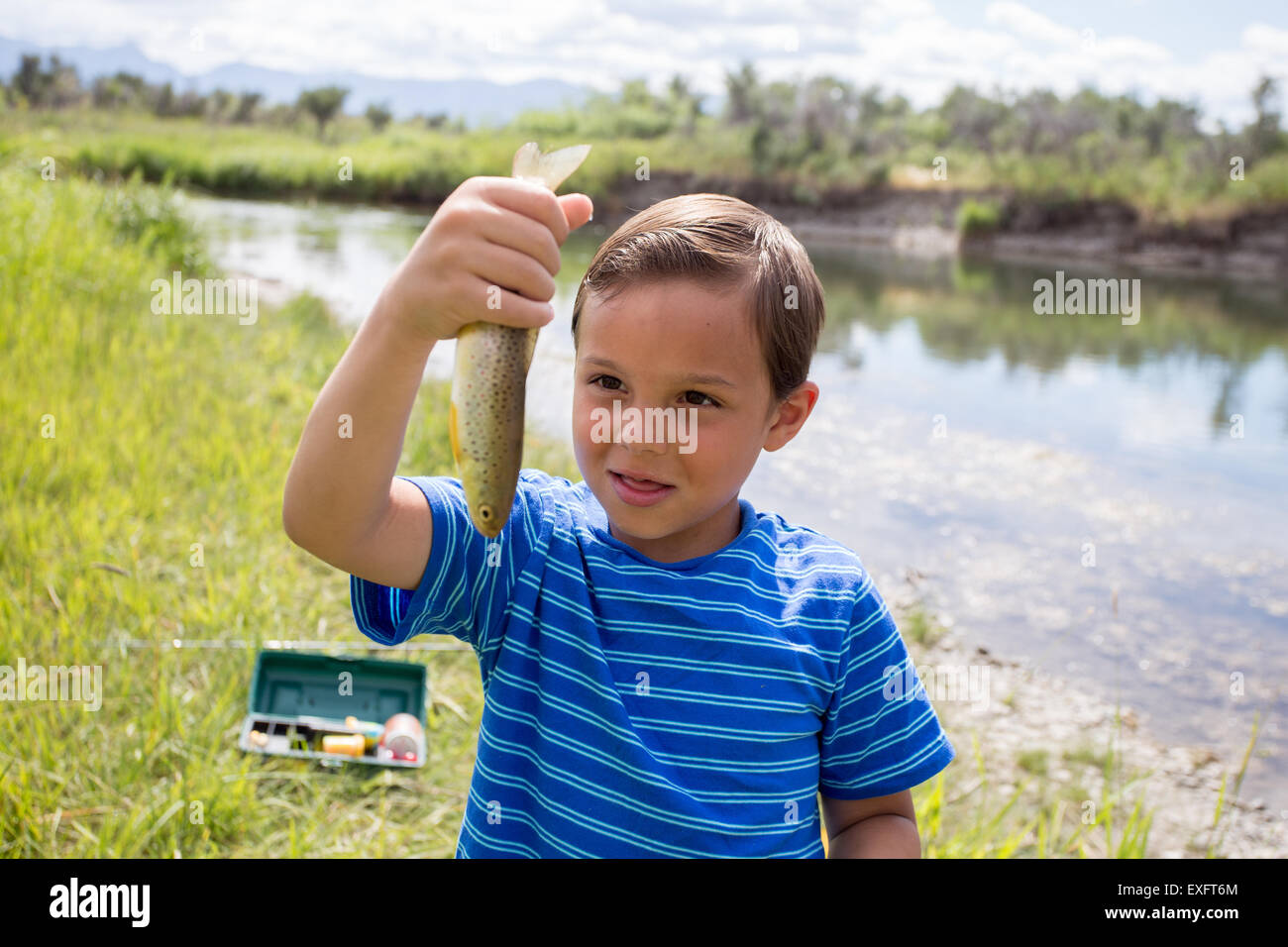 Young boy showing the fish he caught Stock Photo - Alamy