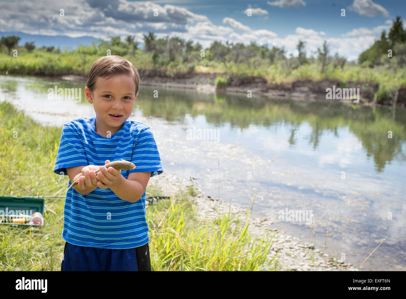 Young boy showing the fish he caught Stock Photo - Alamy