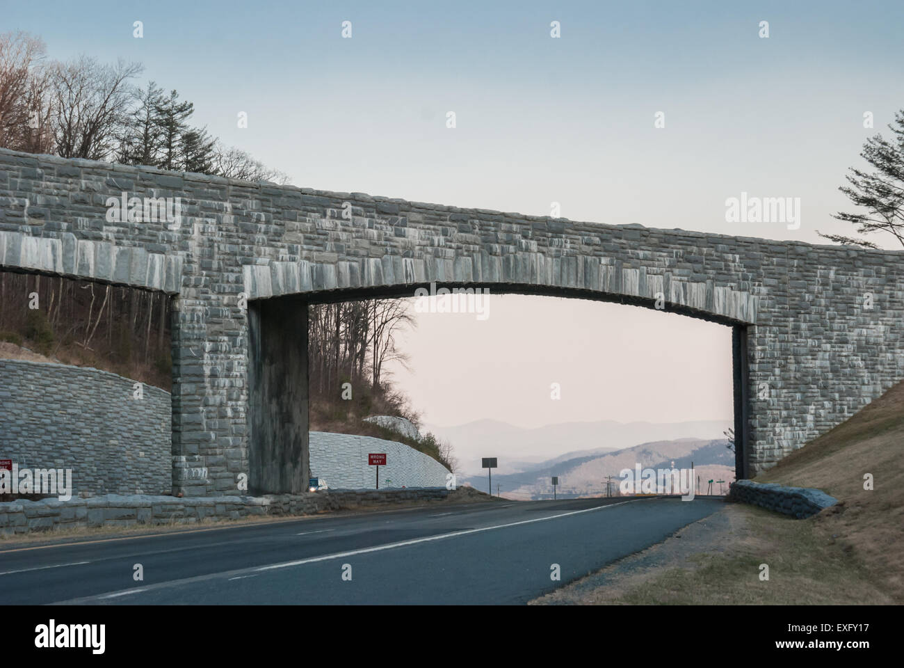 Driving under a stone overpass along the Blue Ridge parkway in winter ...