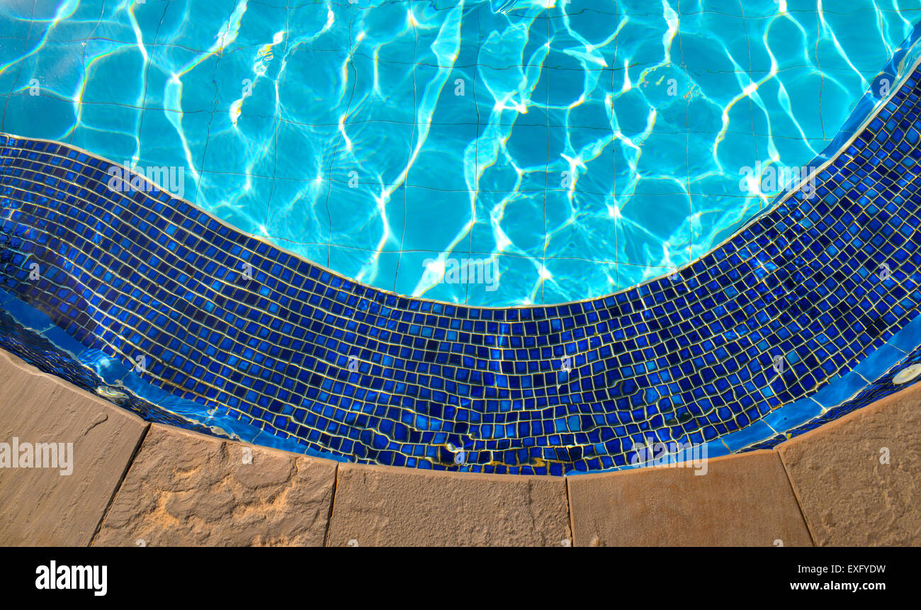 Blue tiles of jacuzzi in the Swimming pool blue water and sunlight ...