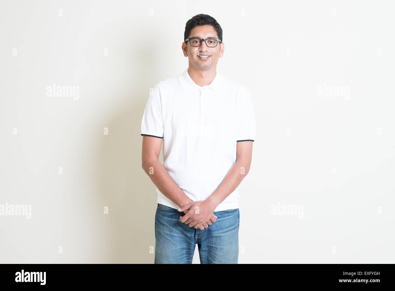Front view portrait Indian guy standing on plain background with shadow ...