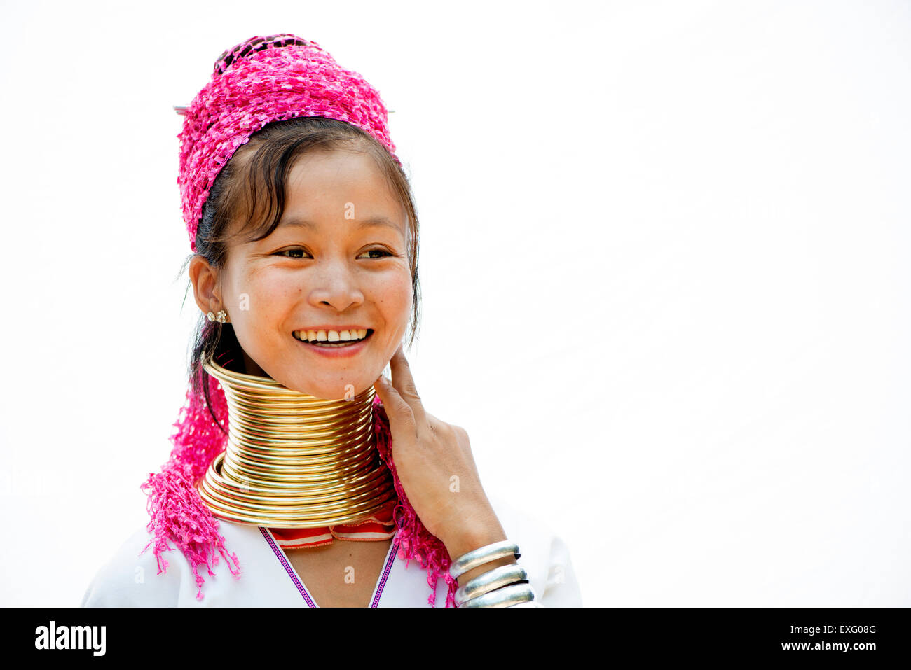 Portrait of a young Kayan hill tribe woman against a white background ...