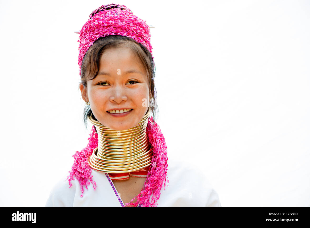Portrait of a young Kayan hill tribe woman against a white background ...