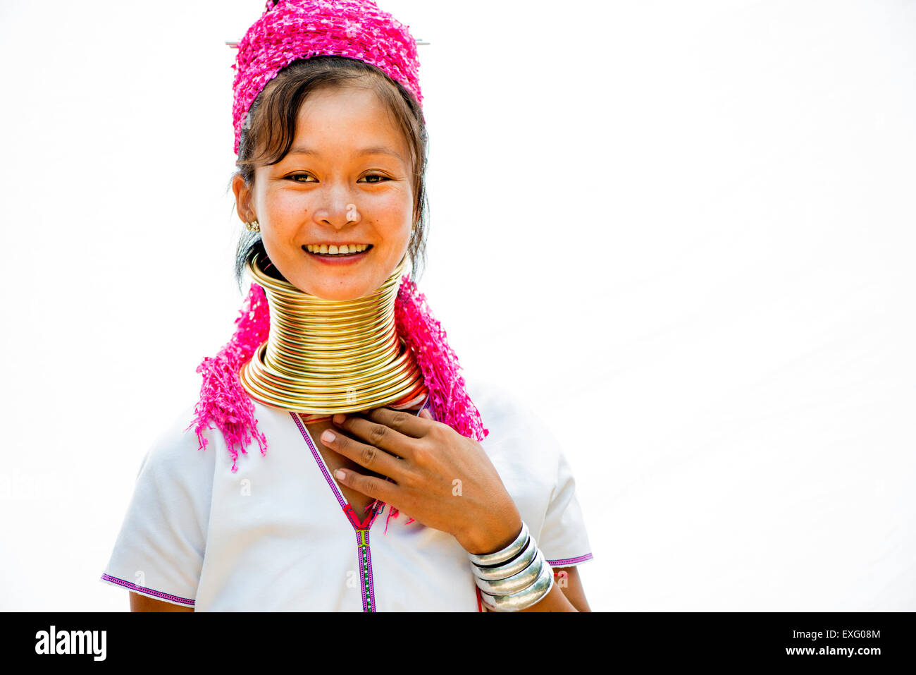 Portrait of a young Kayan hill tribe woman against a white background ...