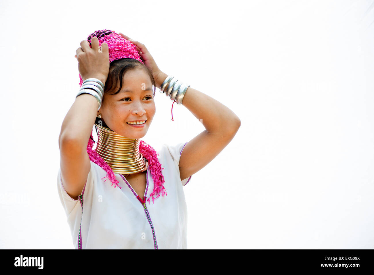 Portrait of a young Kayan hill tribe woman against a white background ...