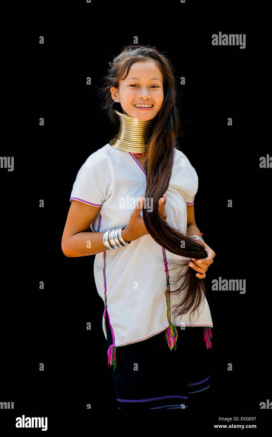 Young Kayan hill tribe woman doing her hair against a black background ...