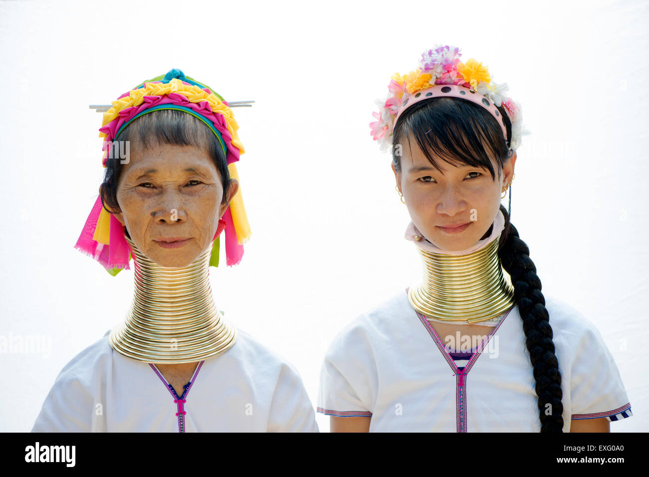 Two Kayan hill tribe women on a white background in Chiang Mai ...