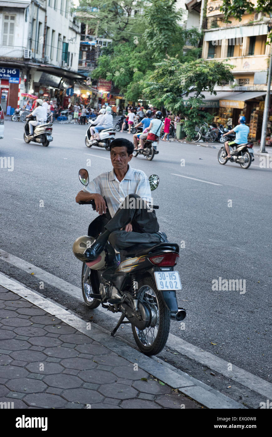 Motorcycle taxi driver at rest, Hanoi, Vietnam Stock Photo - Alamy