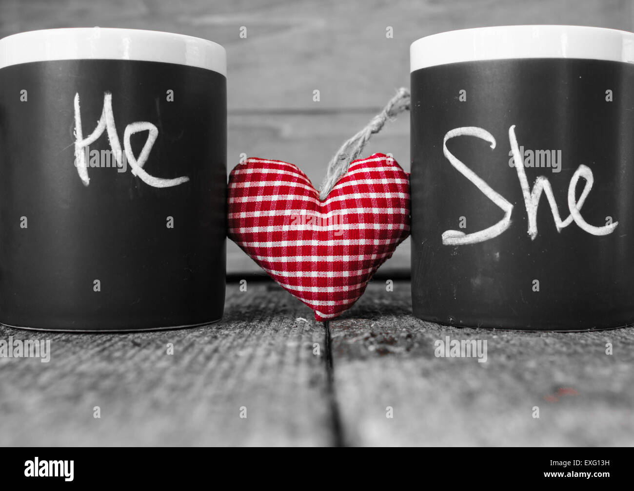Cup with words He and She written with chalk and heart Stock Photo - Alamy