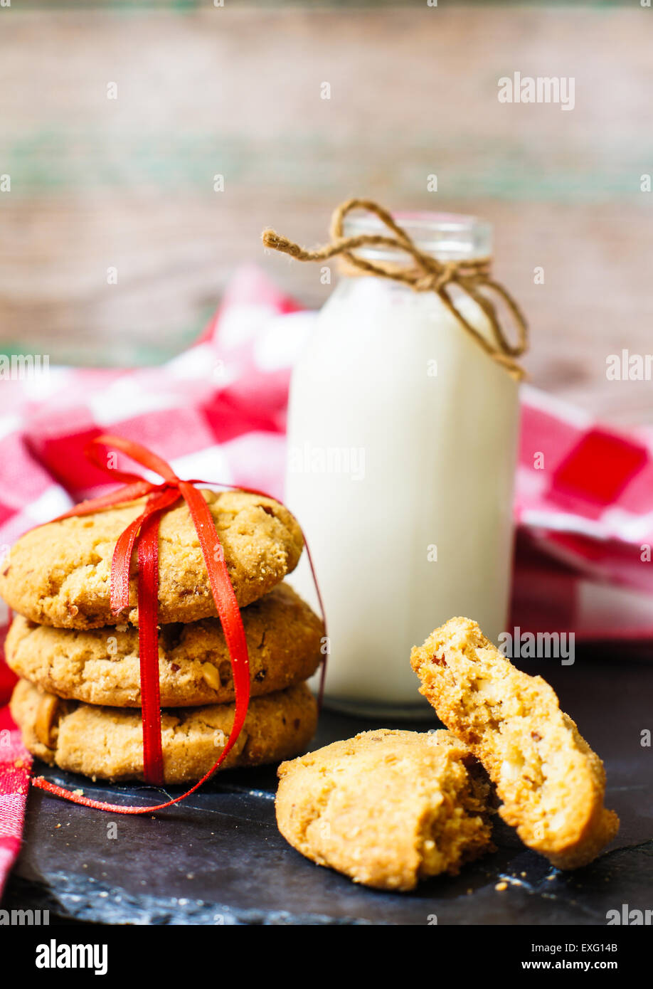 Milk and cookies on the bright napkin on the wooden tray Stock Photo ...