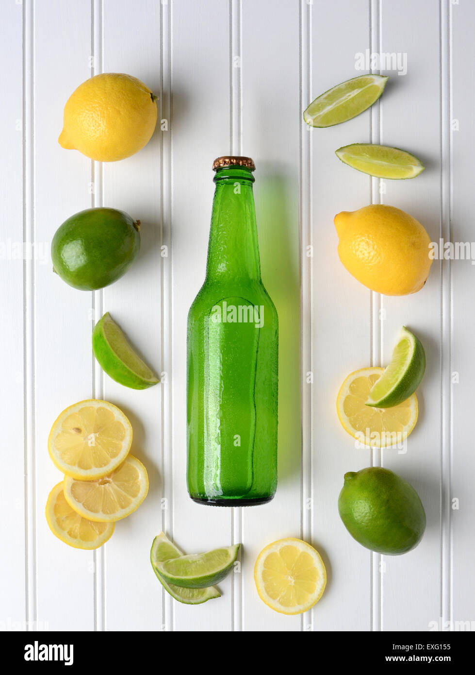 High angle shot of a bottle of lemon lime soda surrounded by fresh cut ...