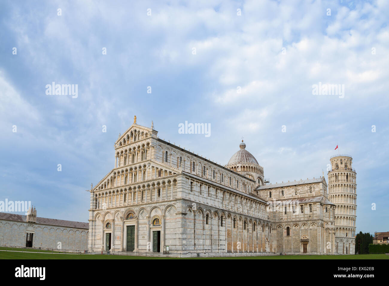 Pisa cloudy sky over Leaning tower and cathedral in square of miracles ...