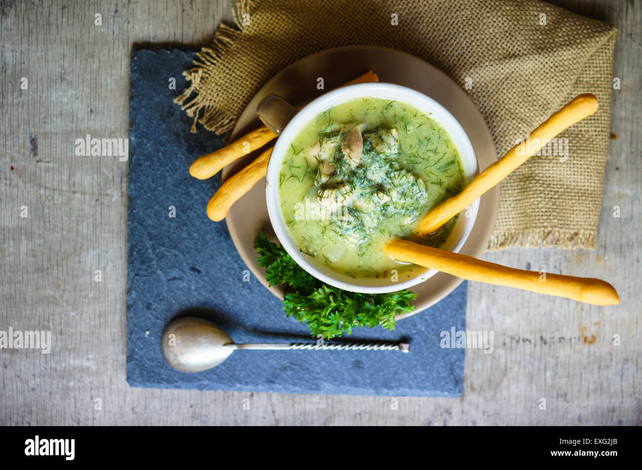 Chicken soup with bread sticks on the rustic kitchen Stock Photo - Alamy