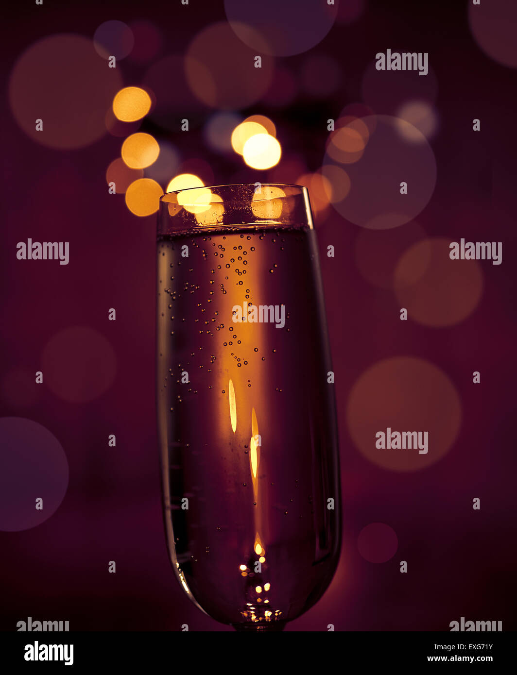 Glass of sparkling wine with blurred lights background Stock Photo - Alamy