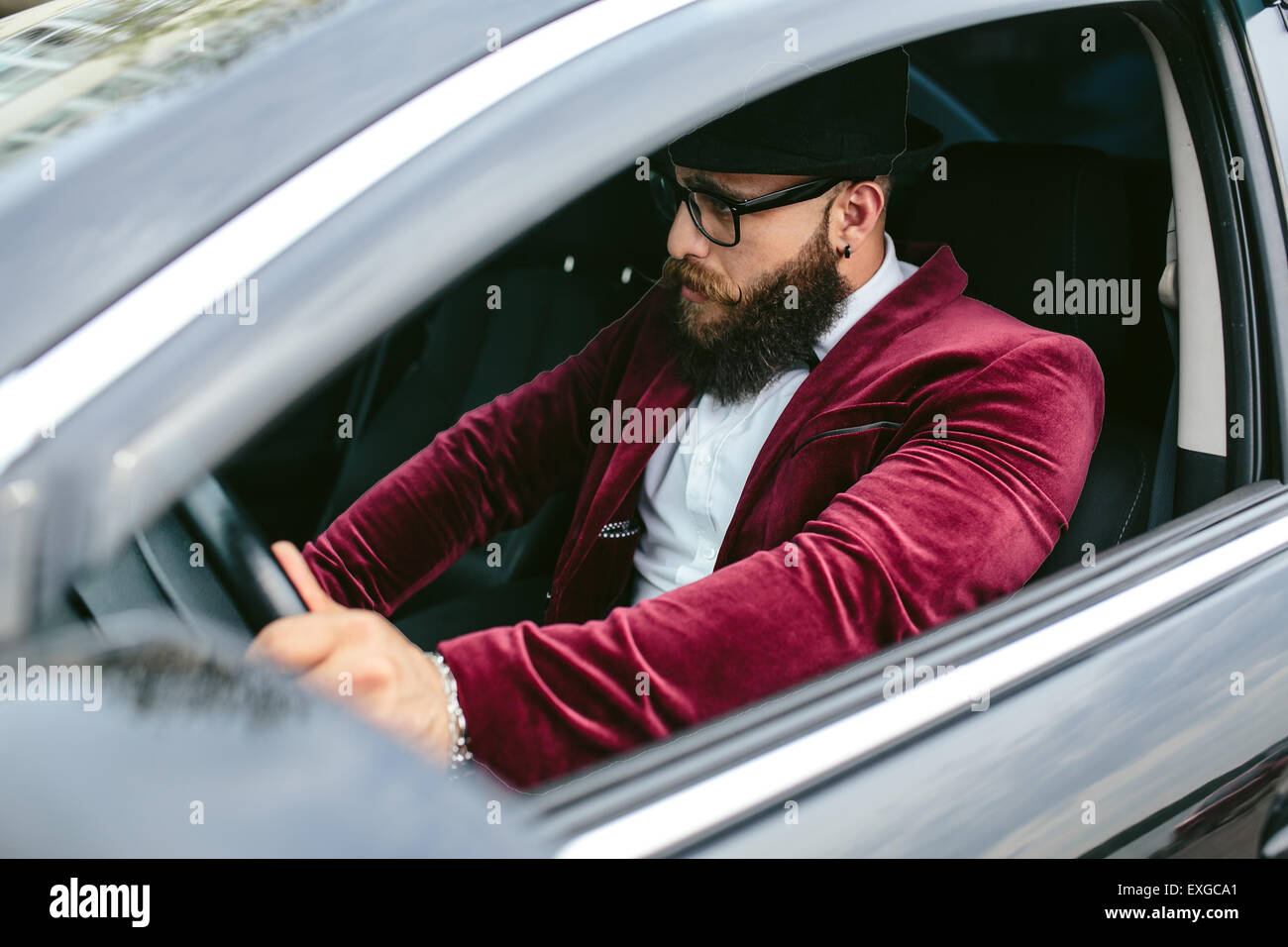 Man with beard driving a car Stock Photo - Alamy