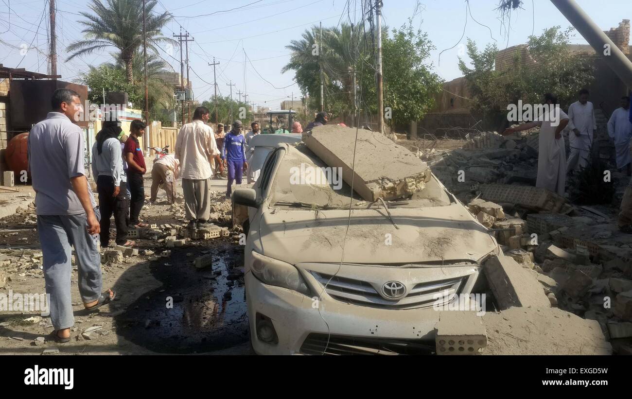 Fallujah, Iraqi capital Baghdad. 14th July, 2015. People gather around ...