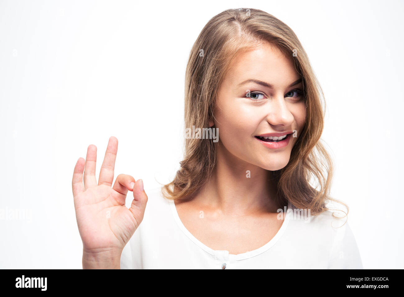 Happy young woman showing ok sign with fingers isolated on a white ...