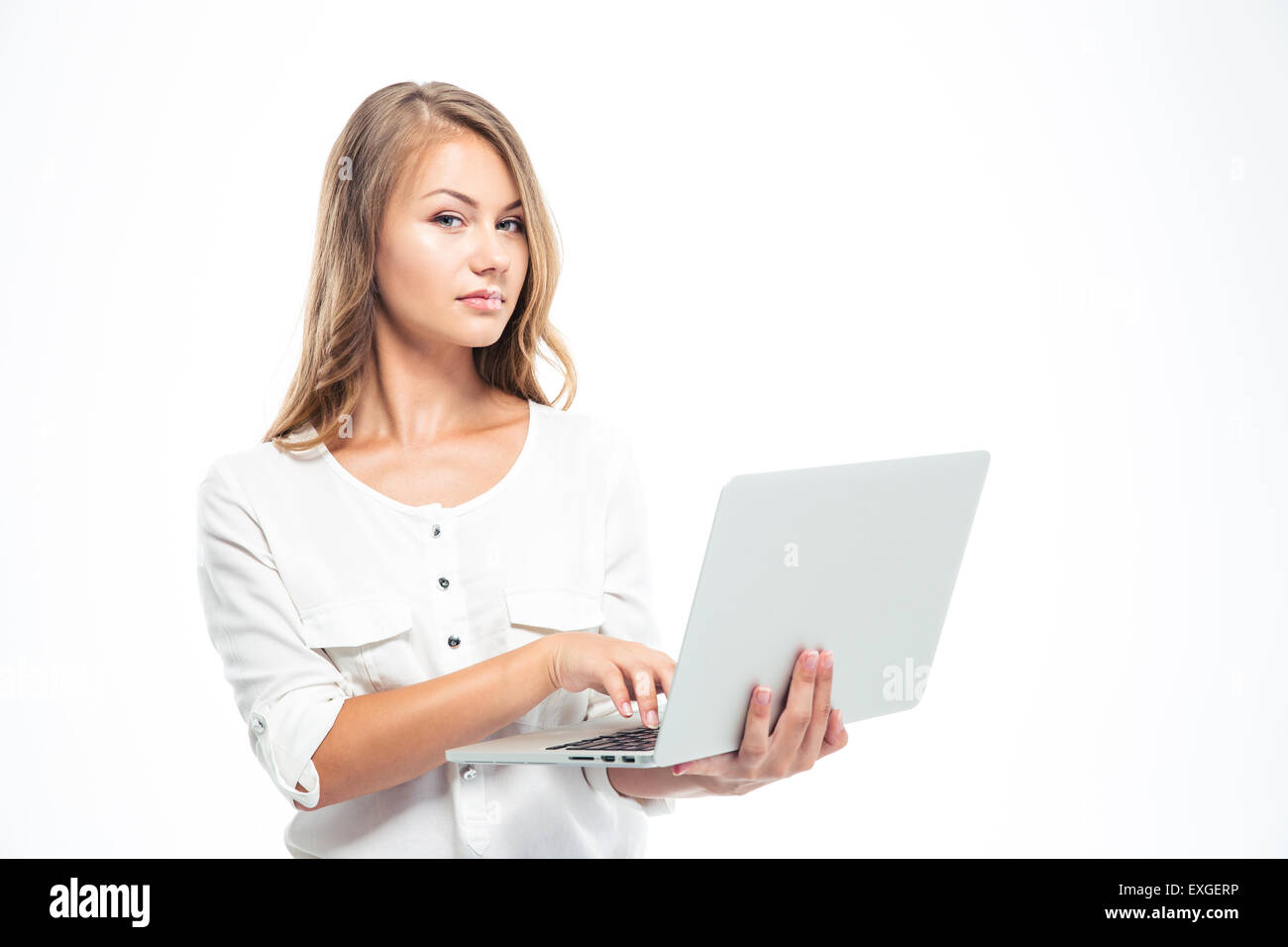 Beautiful young woman standing with laptop isolated on a white ...