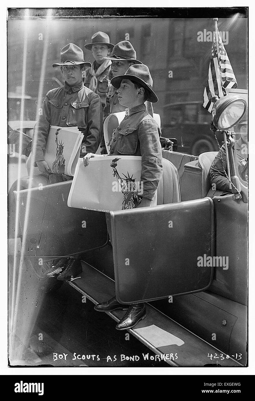 This historical image depicts Boy Scouts performing duties as bond ...