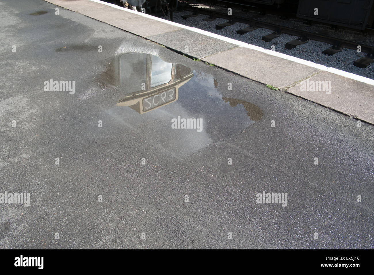 Reflection of train in a puddle Stock Photo - Alamy