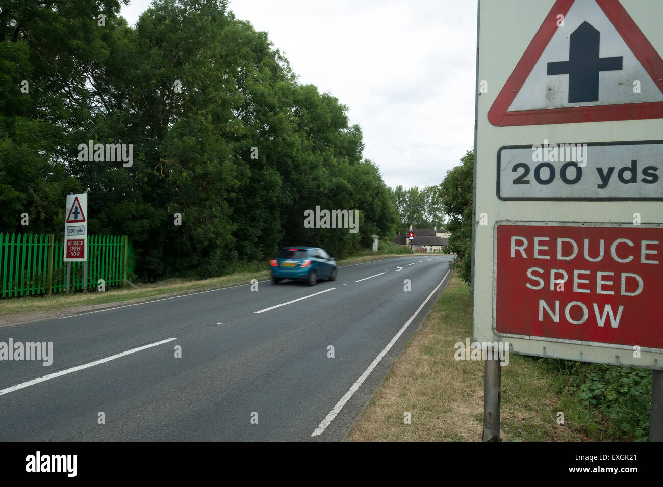 Car and reduce speed sign Stock Photo - Alamy