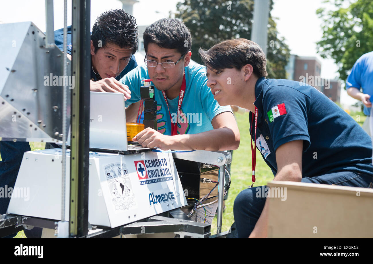 Members of the Lunambotics team prepare their robot for the level one challenge in the 2015 NASA ...