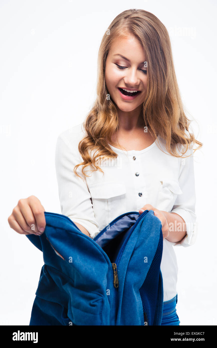Smiling female student opening her backpack isolated on a white ...