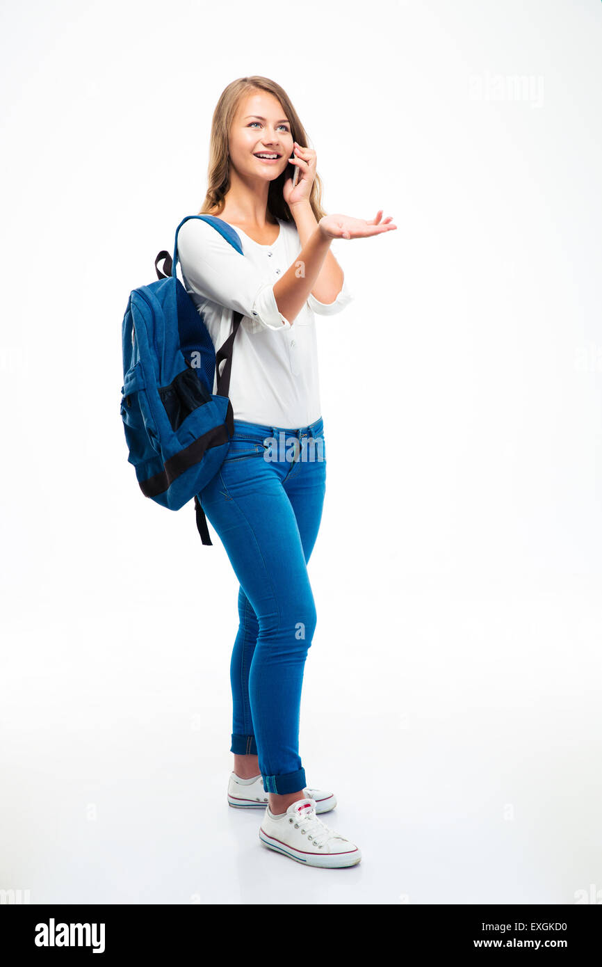 Full length portrait of a happy female student talking on the phone ...