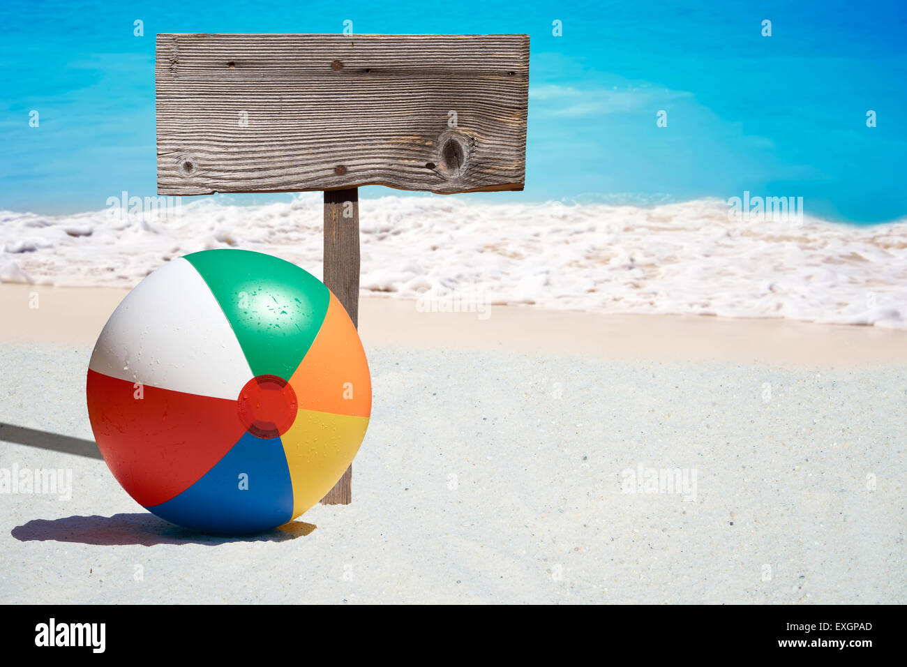Colorful Beach Ball and a wooden Signboard on the Beach Stock Photo - Alamy