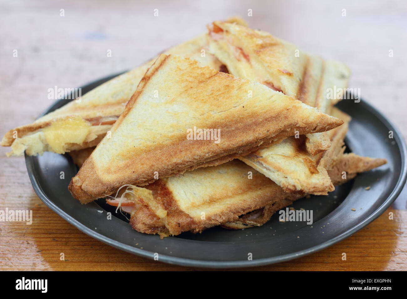 Triangle cheese and ham toasted sandwiches Stock Photo - Alamy