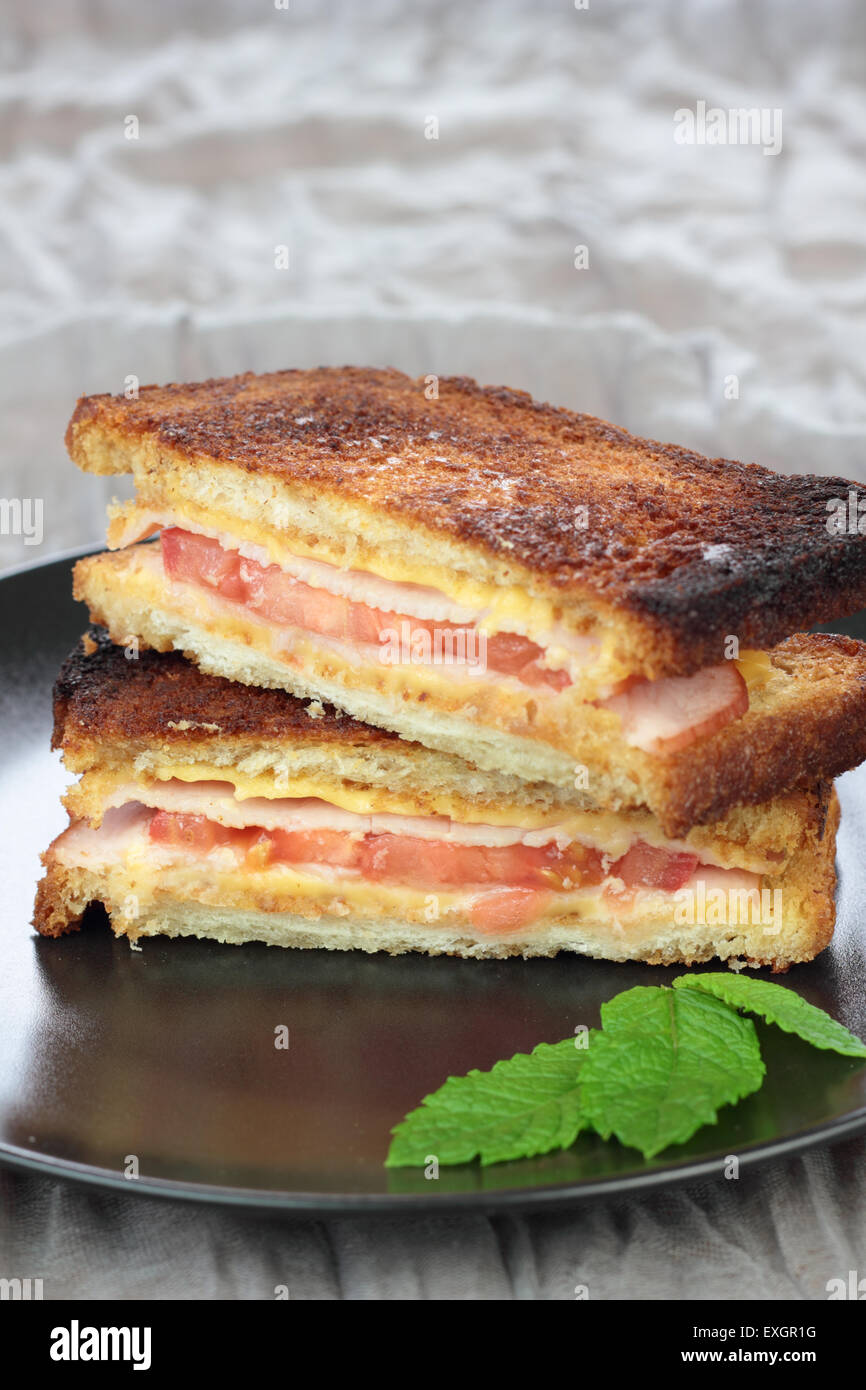 Closeup of halved ham and swiss cheese toast Stock Photo - Alamy