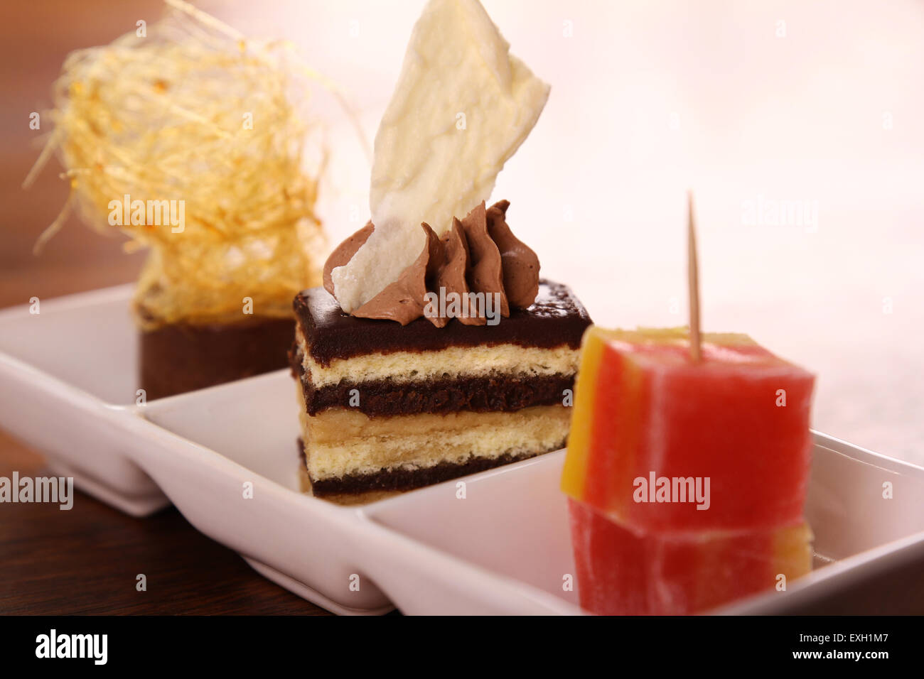 Three beautiful delicious gourmet desserts on a white plate. Chocolate ...