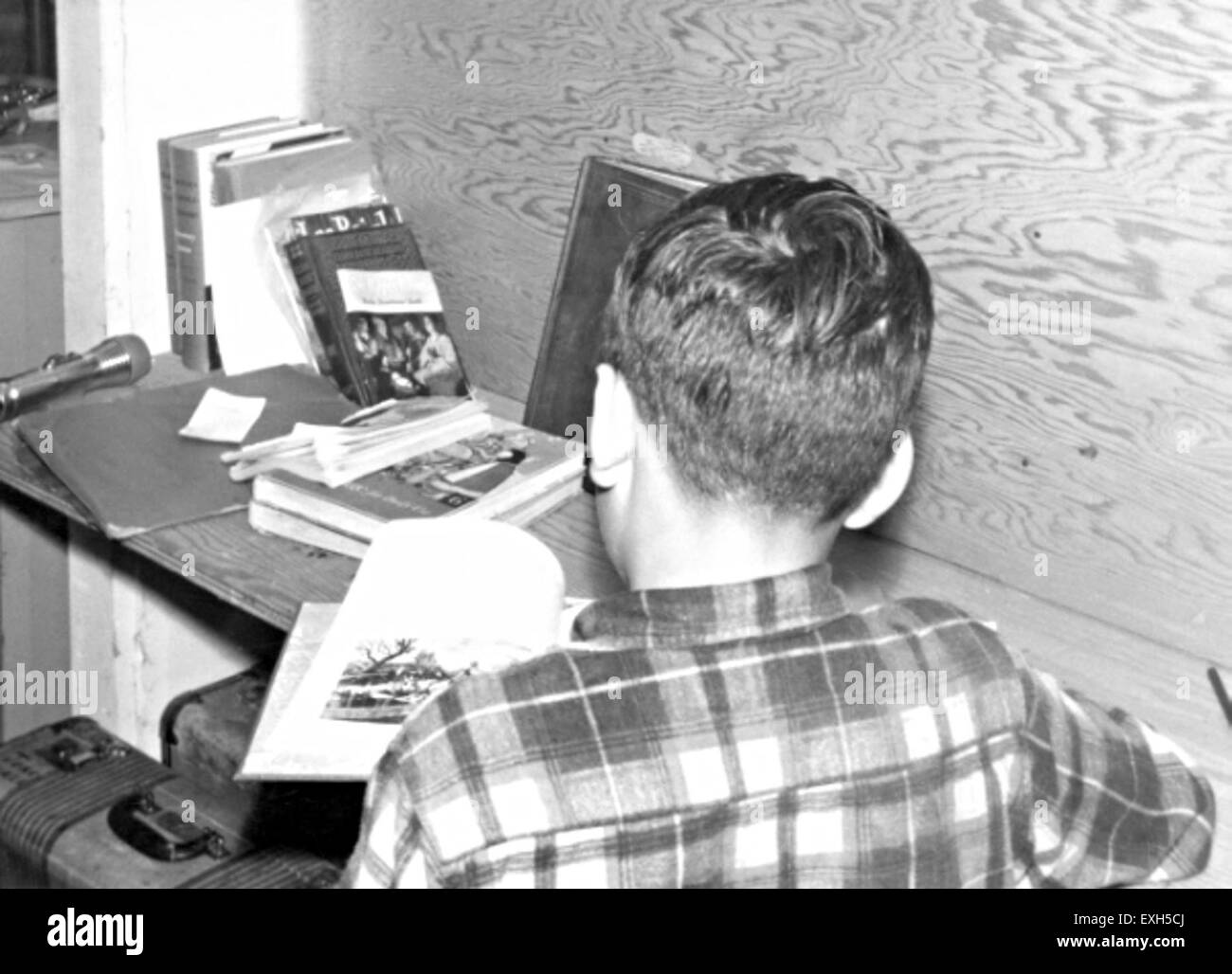 Billy is shown doing homework in 1963, reflecting the daily life and ...