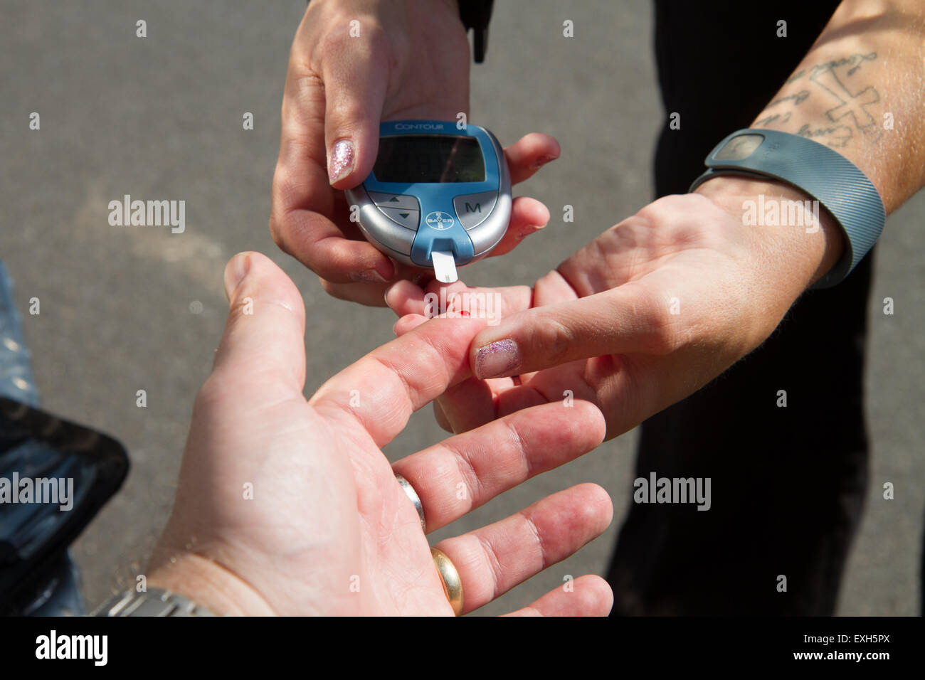 EMT / Paramedic administers blood sugar test in ambulance Stock Photo ...