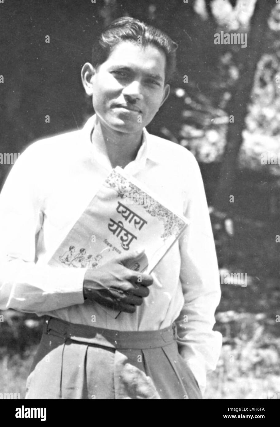 C.K. Jabier, a translator, is pictured with a Bible school book in ...