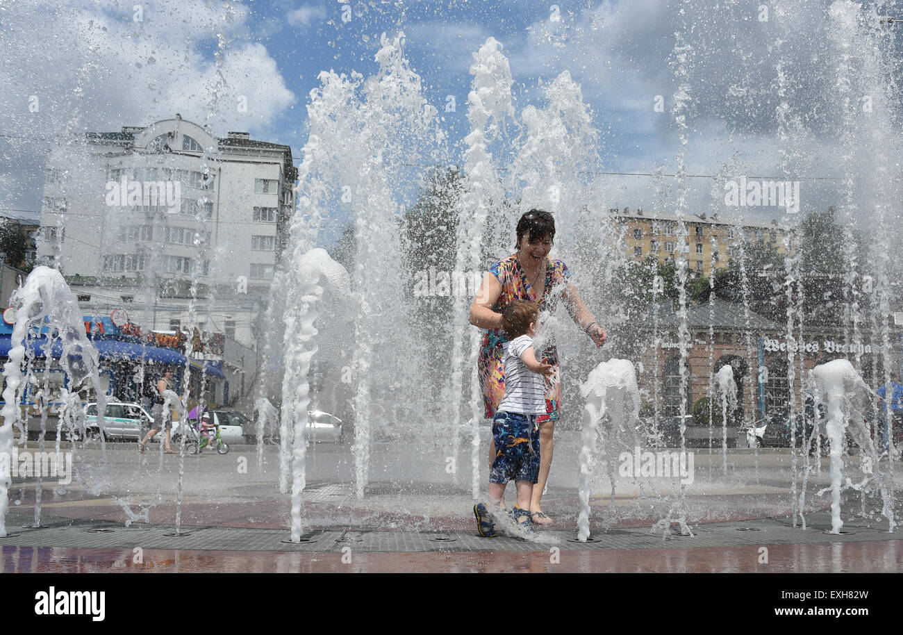 Rostov-on-Don, Russia. 14th July, 2015. A woman stands next to a boy in ...