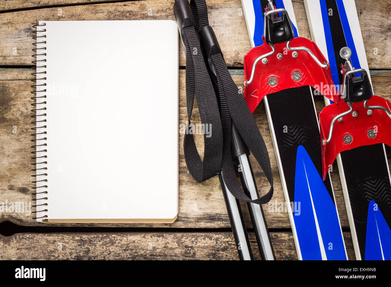 Ski background with empty paper notebook. Ski with poles on old ...