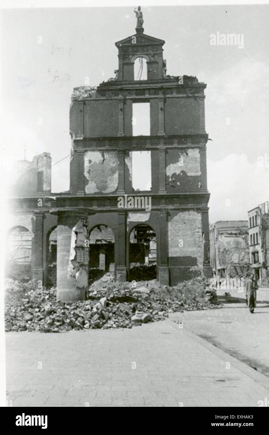 A photograph showing a destroyed building, likely a result of conflict ...
