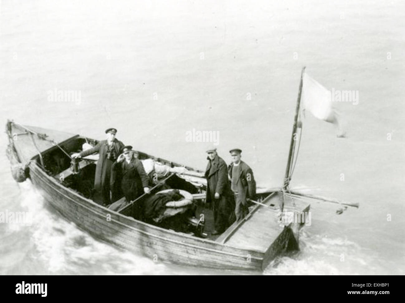 This image shows four men in a boat, likely engaged in a water-based ...