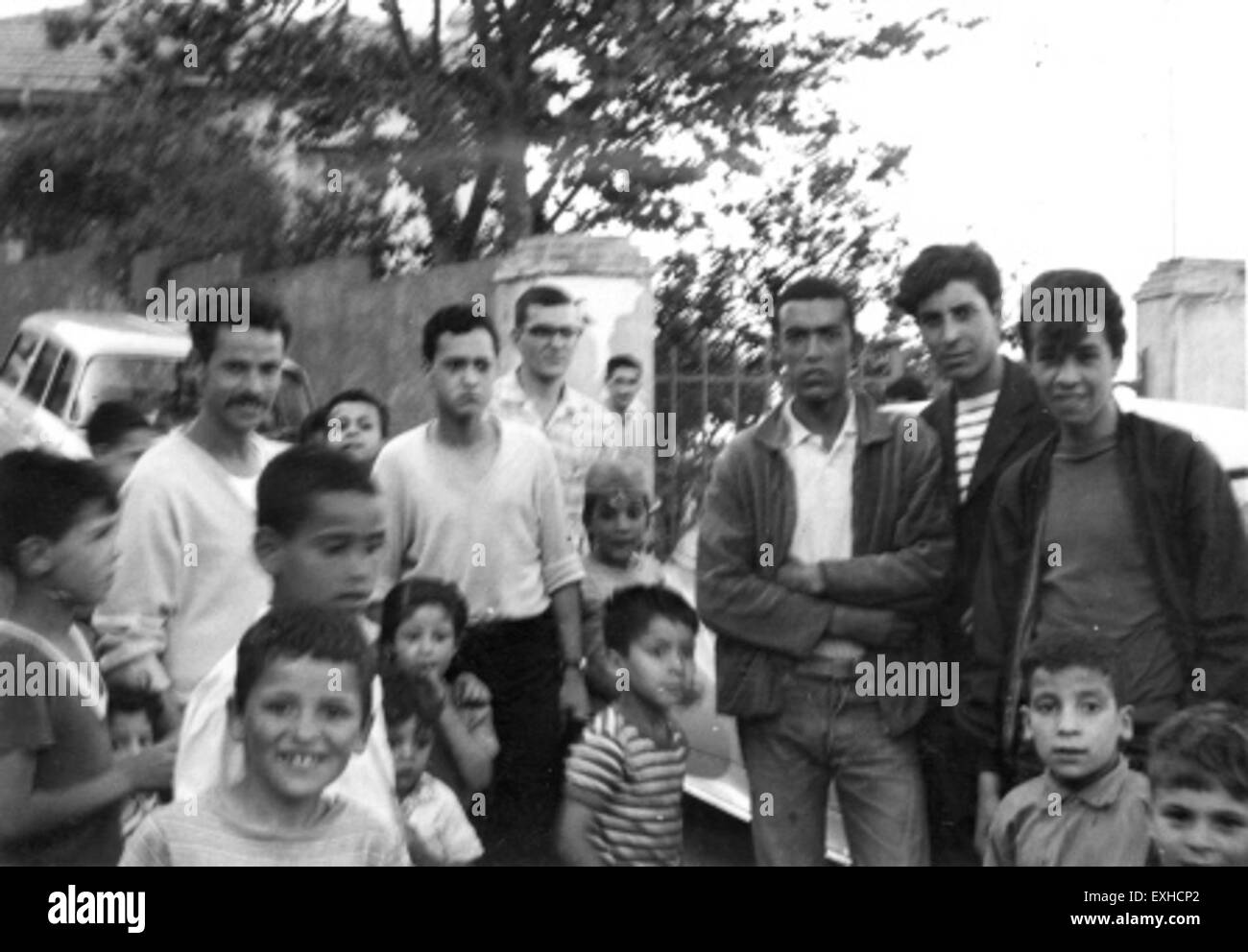A photograph showing a group of men and boys in Algeria, emphasizing ...