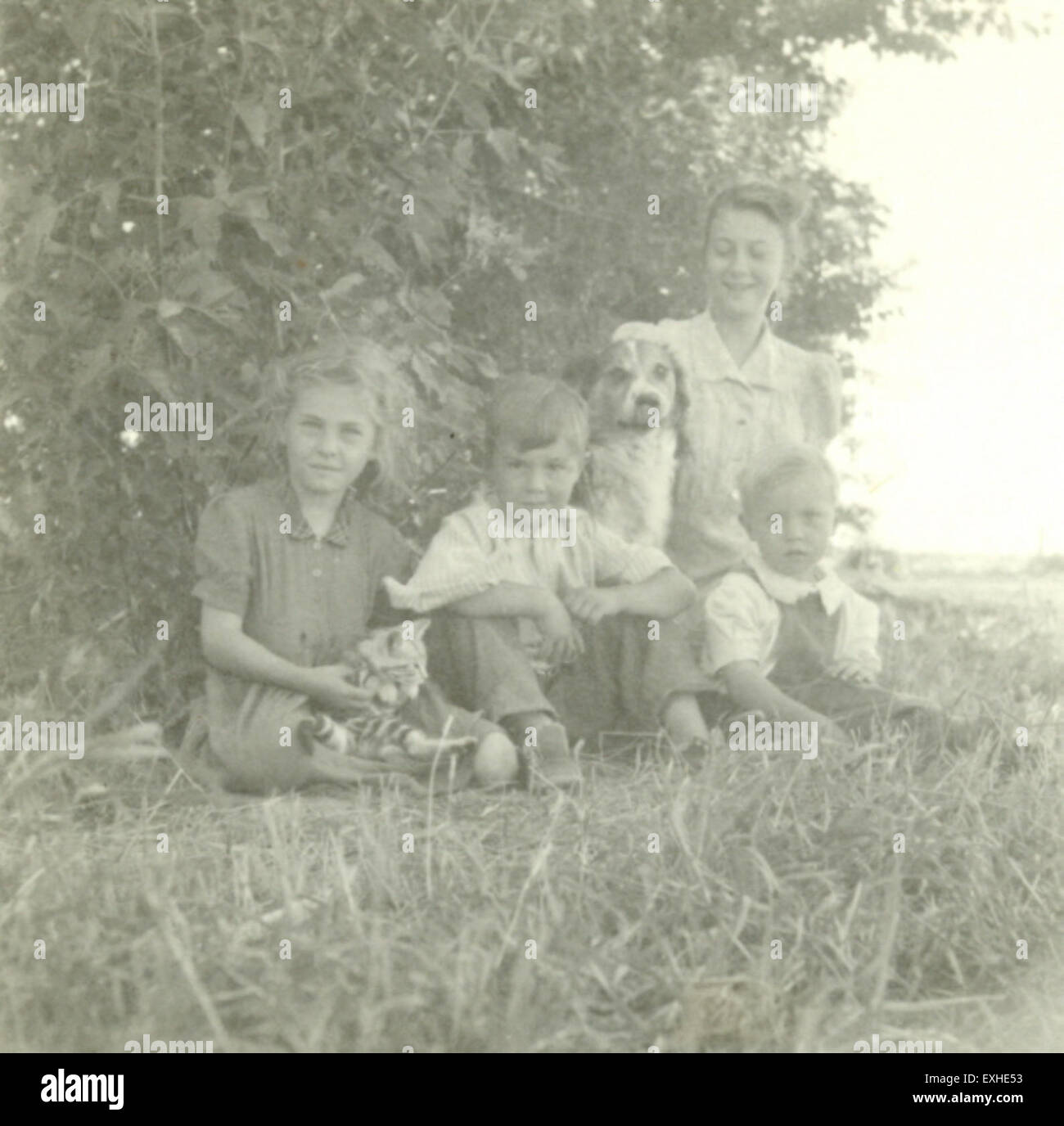 The image shows Irvin Wenger and his family, including children, in ...
