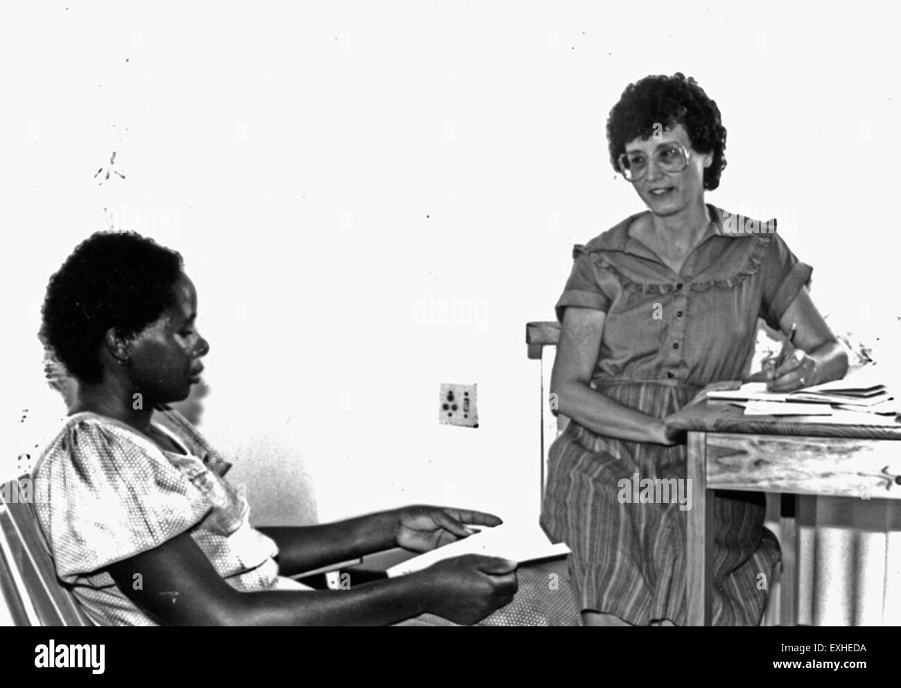 Jean Isaac, shown with a language helper, is engaged in a process ...