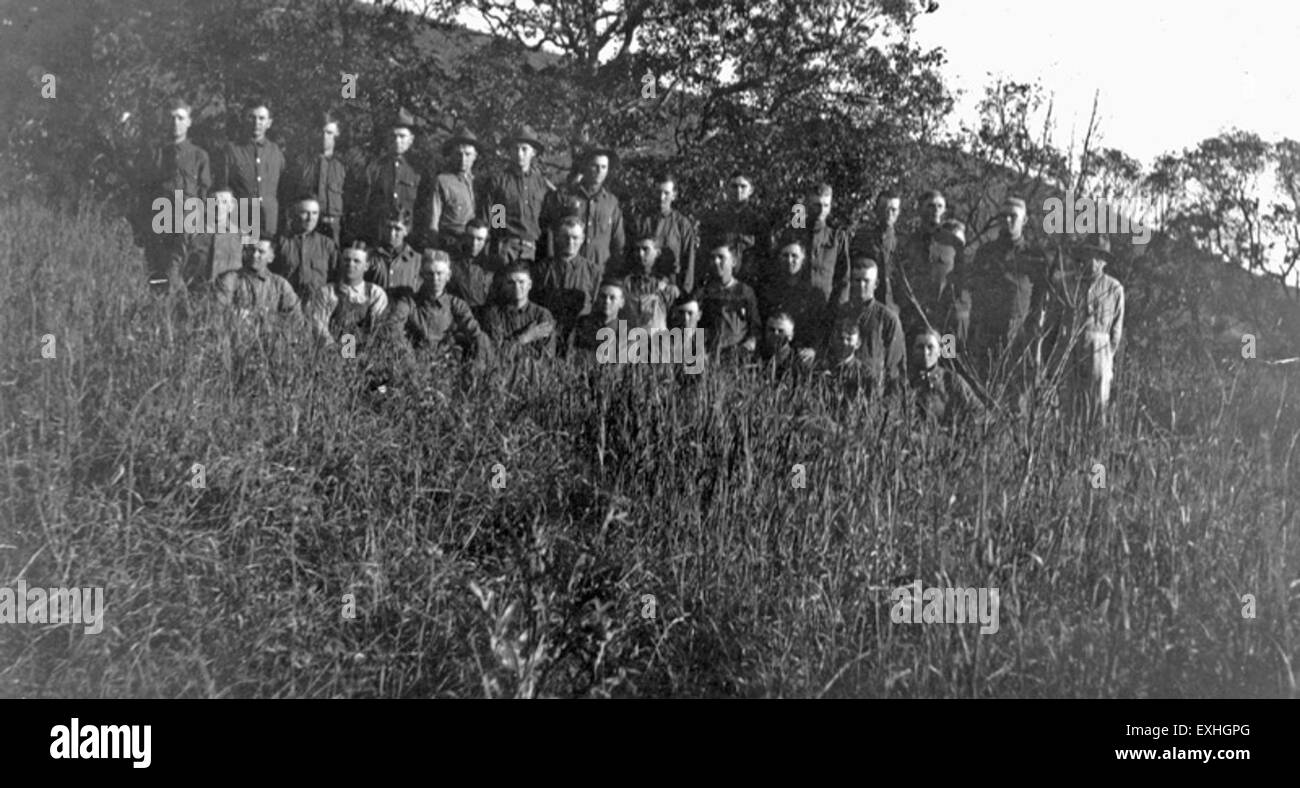 This photograph features a group of men posing at Camp Funston, a major ...