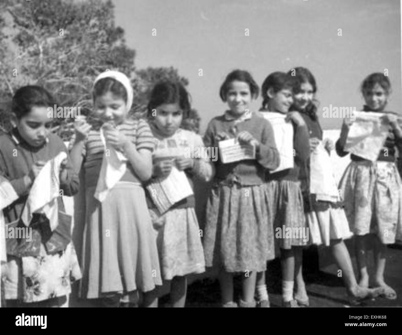 The image shows Moslem girls attending a sewing class in Algeria ...