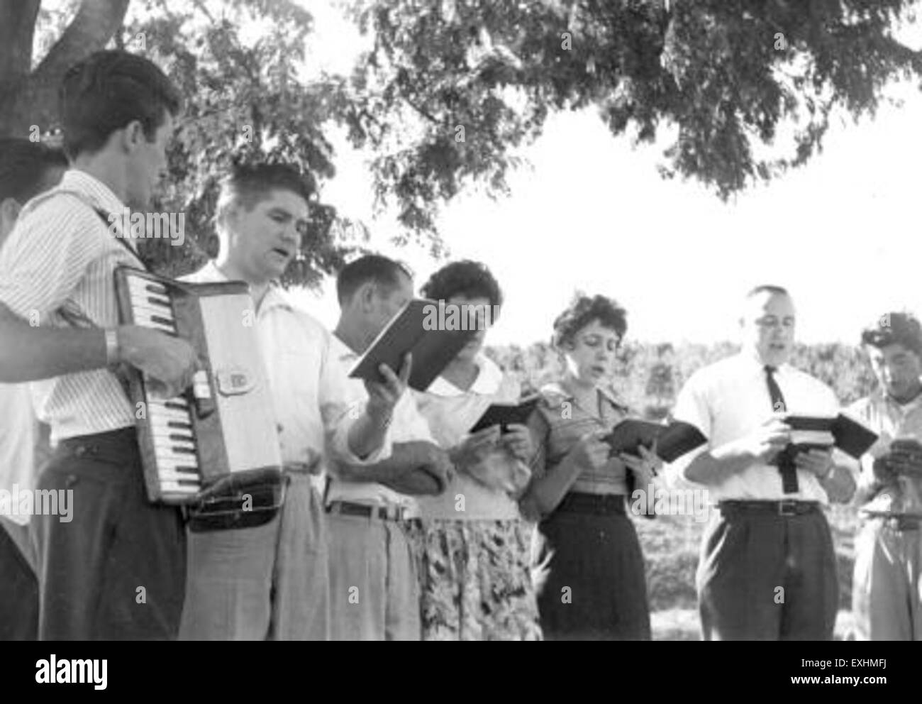This photograph depicts an outdoor religious gathering, showing ...