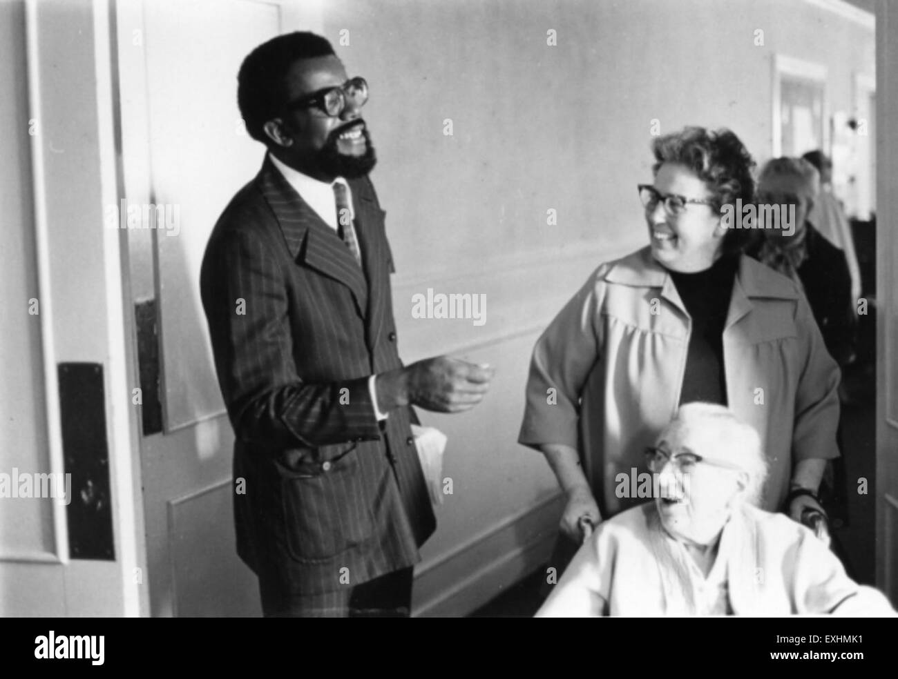 A photograph capturing Pastor Hubert Brown greeting people in 1982. The ...