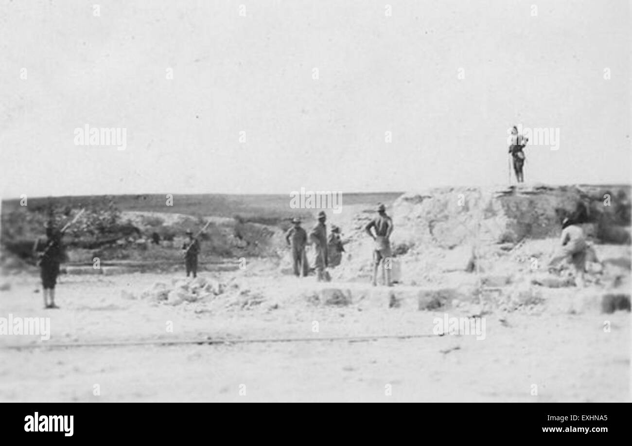 This historical image shows a group of prisoners working in a quarry ...