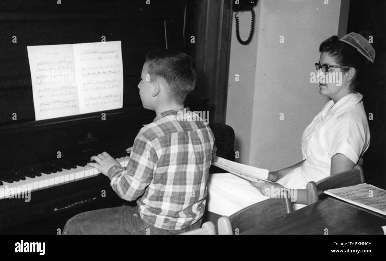 In this image, Ramona Wertz assists Ronald with his piano practice ...