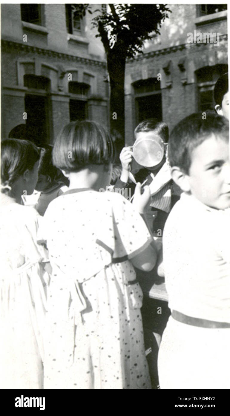 This historical photograph shows children receiving breakfast during ...